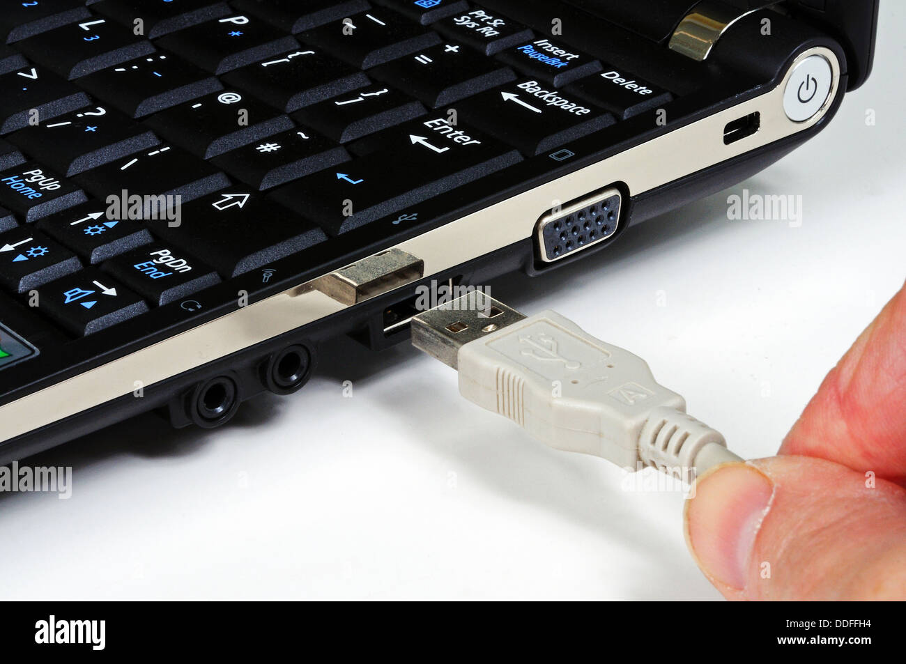 USB cable being plugged into side of netbook Stock Photo - Alamy
