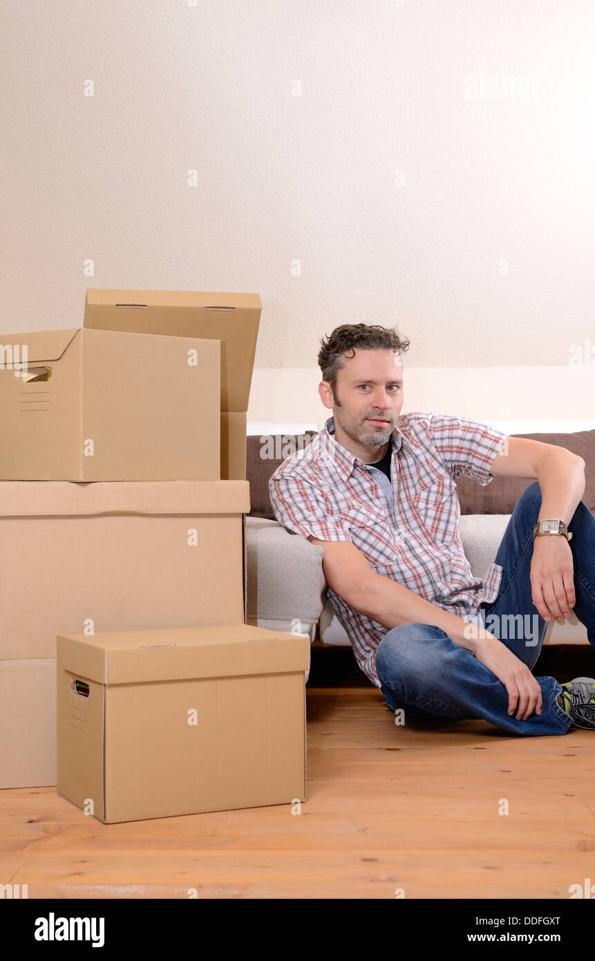 Happy man moving in new home Stock Photo - Alamy