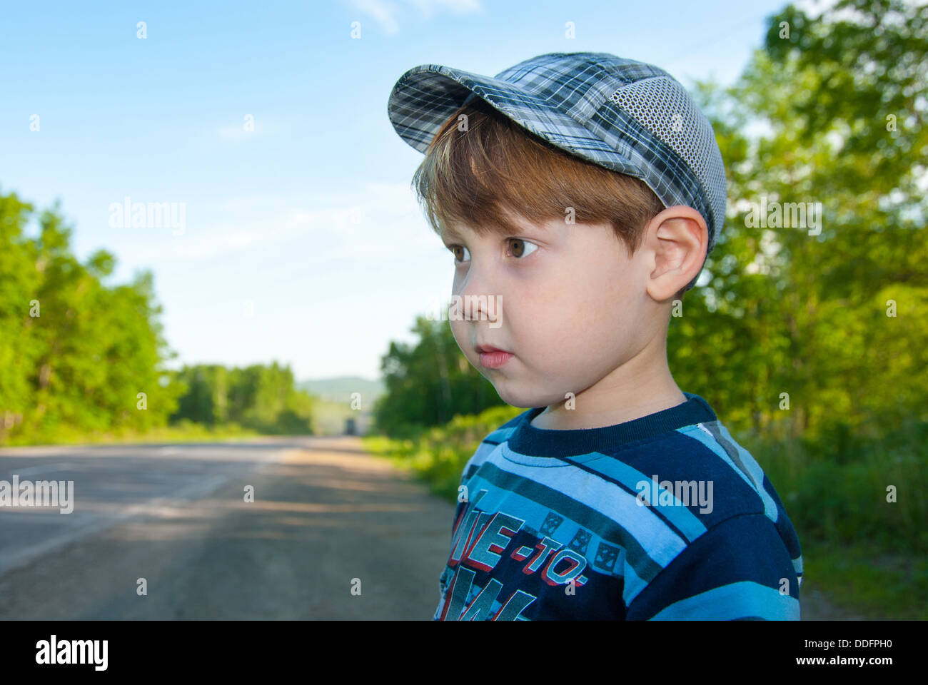 The little boy in a cap looks an amazed look Stock Photo - Alamy