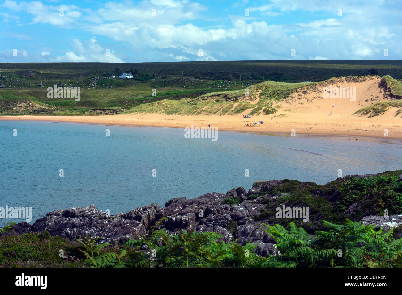 Bay with sandy beach, sand dunes, single white house, sand dunes, blue ...