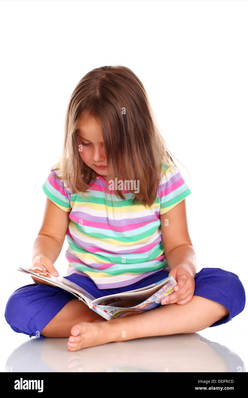 Cute little girl reading book Stock Photo - Alamy