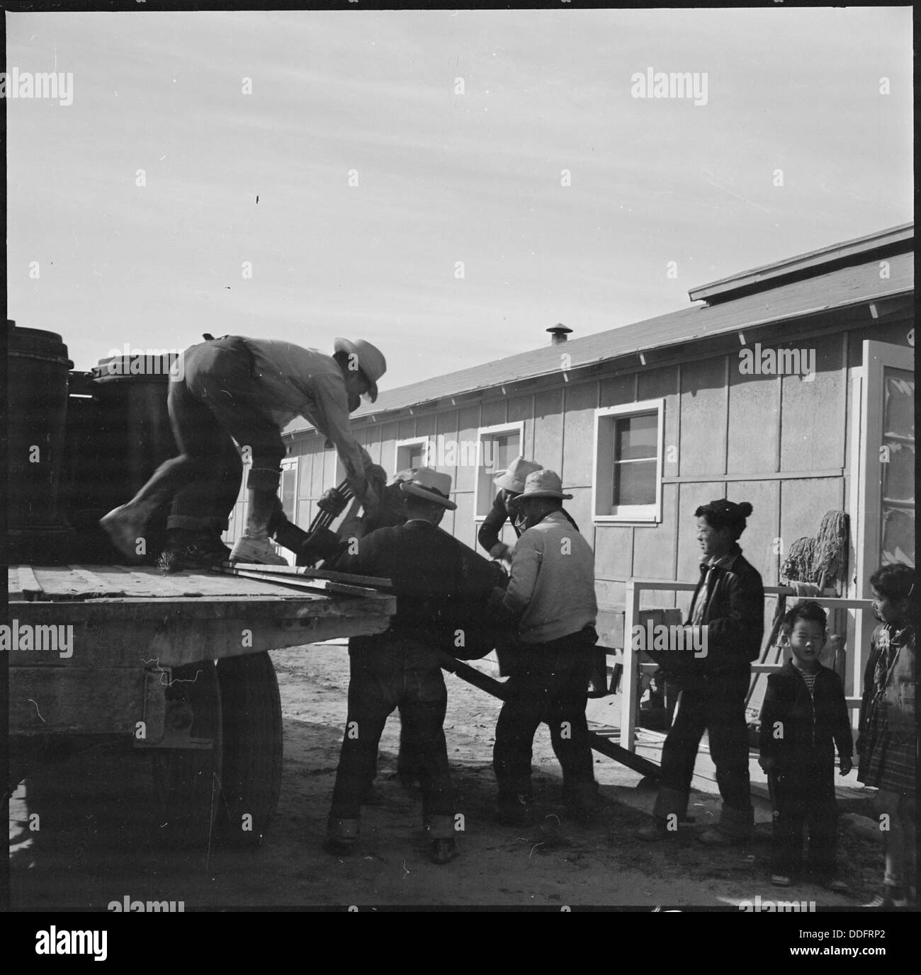 A crew delivers United States Army Number 1 space heaters to a resident ...