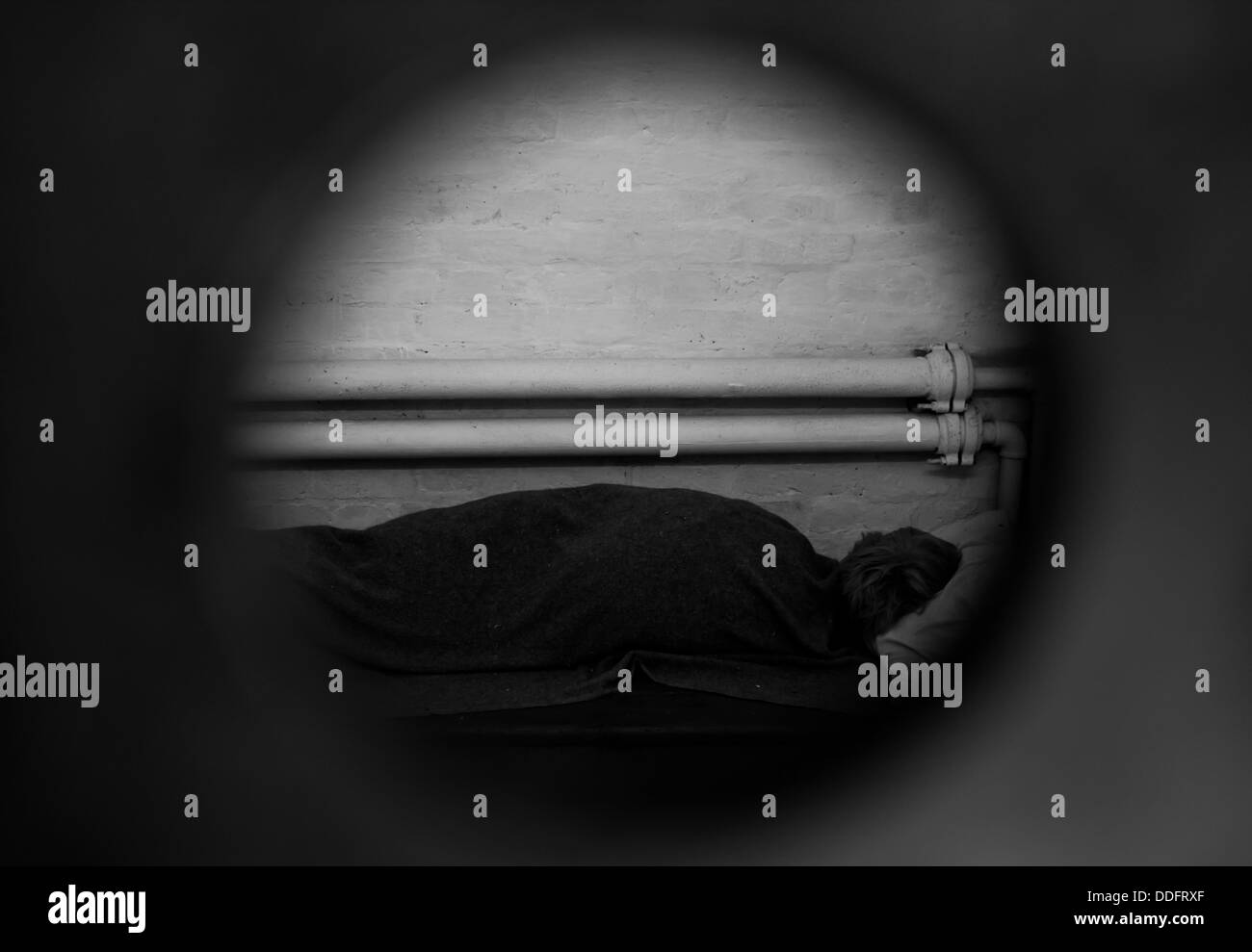 Prisoner in bed asleep through the looking hole. (Dummy prisoner, not a ...
