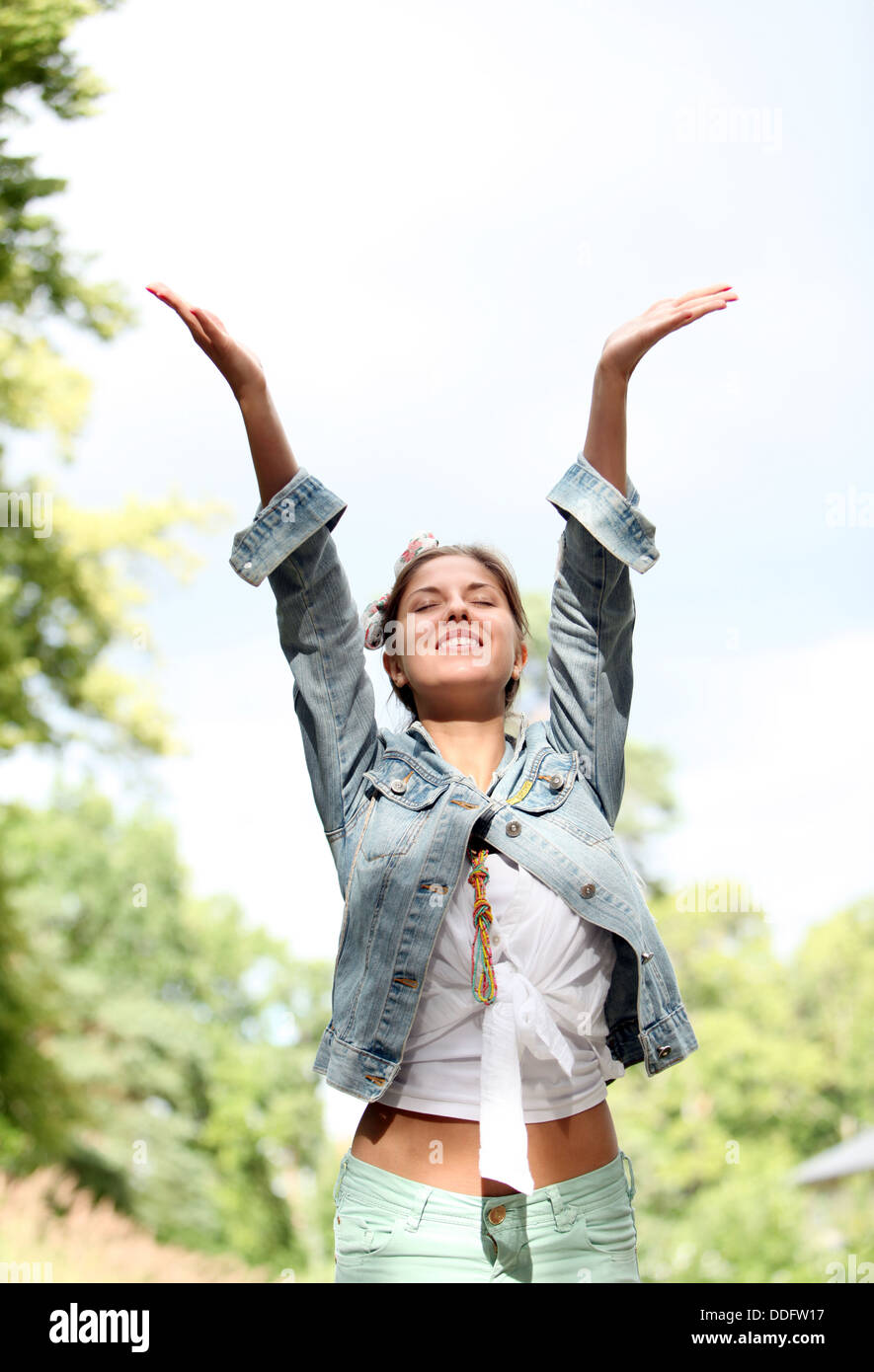Young smiling woman raise her hands up Stock Photo - Alamy