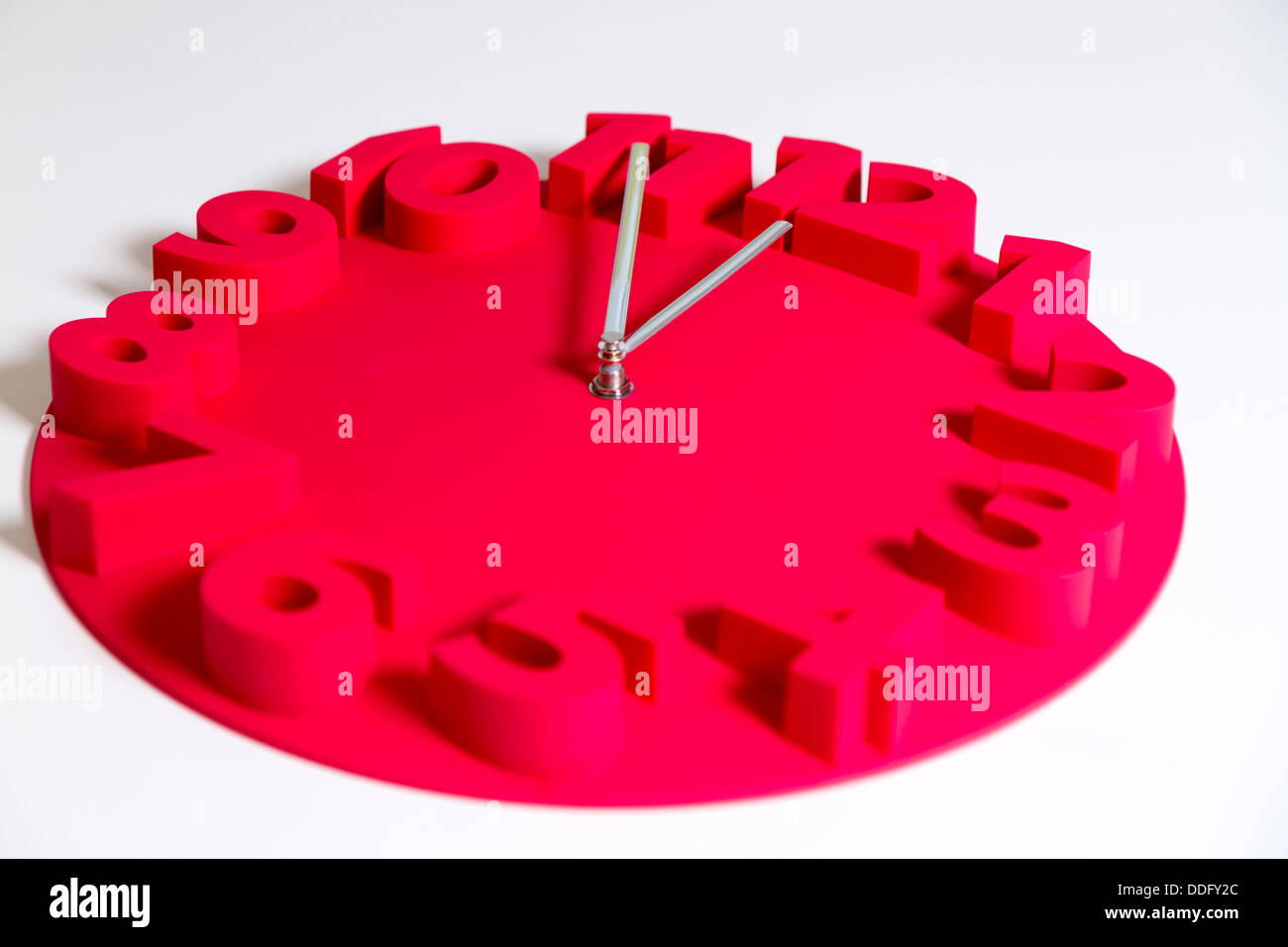 Red clock on isolated white showing five minutes to midnight Stock ...