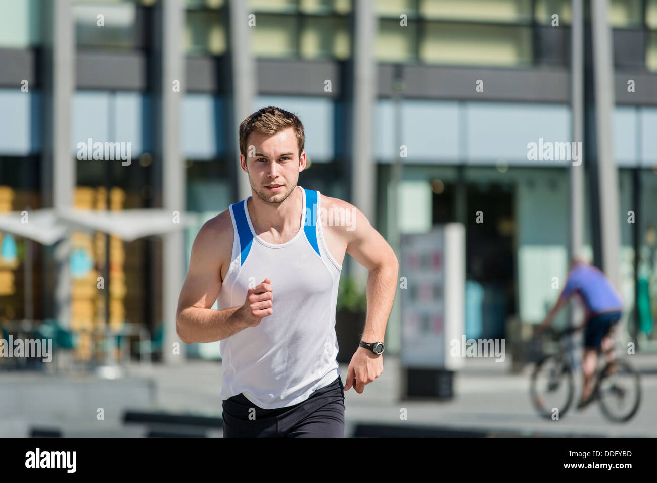 Running lifestyle - young sport man jogging in street Stock Photo - Alamy