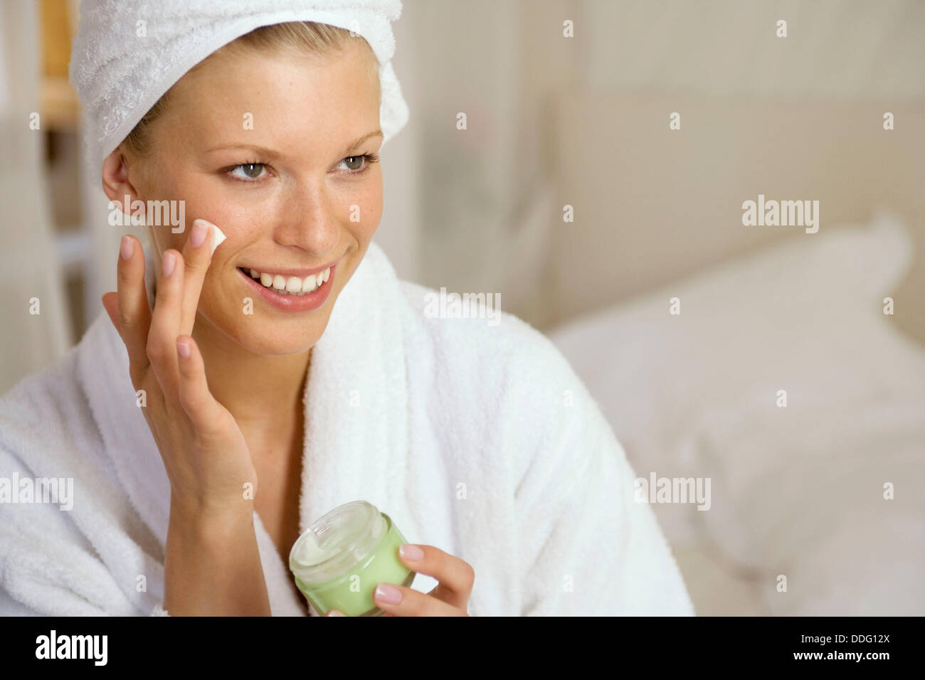 Mid adult woman face cream apply hi-res stock photography and images ...