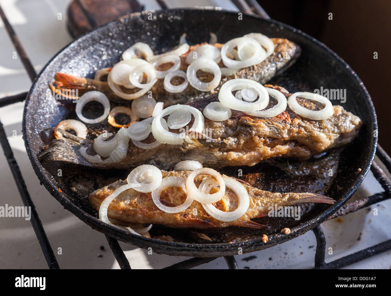 Fried fish in a frying pan Stock Photo - Alamy