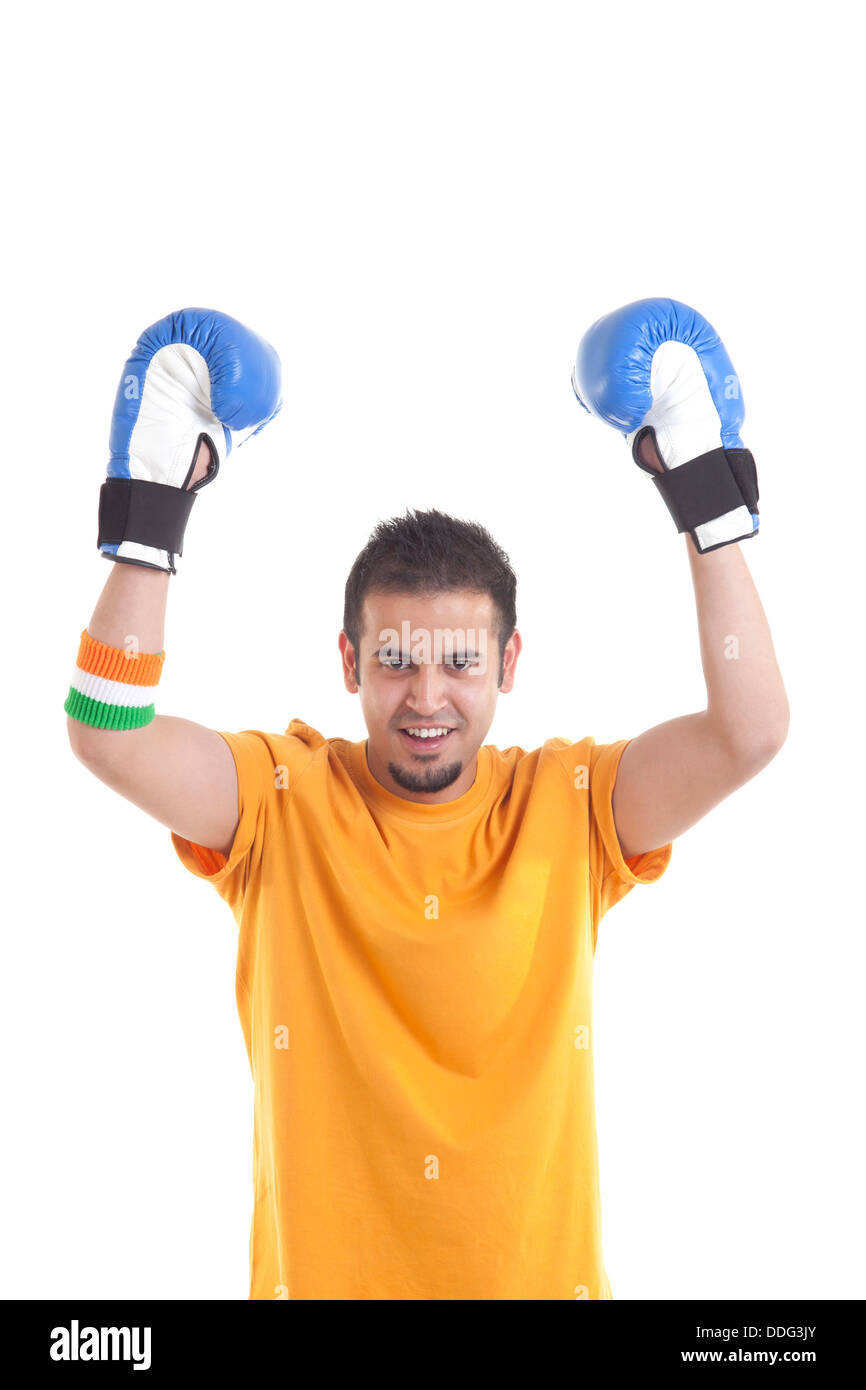 Portrait of Indian male young boxing player with arms up isolated over ...