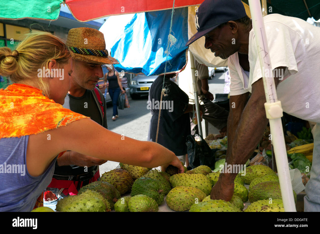 Tourist purchasing Soursop at fruit and vegetable market, St. George's ...