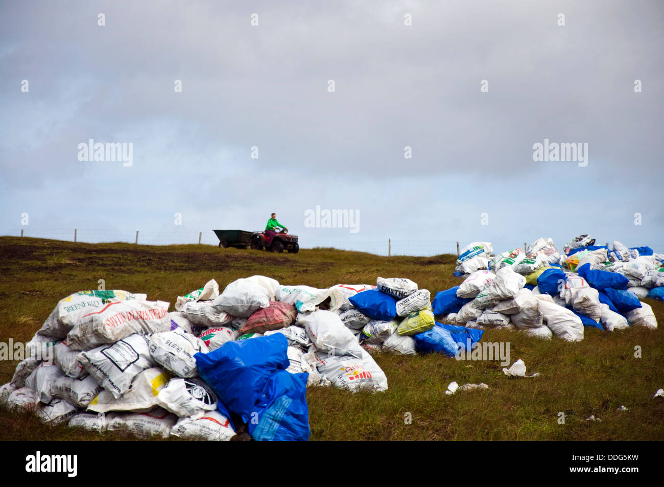 Plastic sacks bags of dried turf awaiting collection near Glencomcille ...