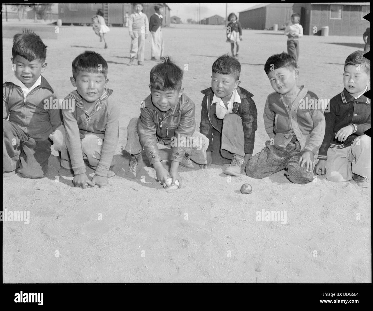 Children are seen playing in a field at the Manzanar Relocation Center ...