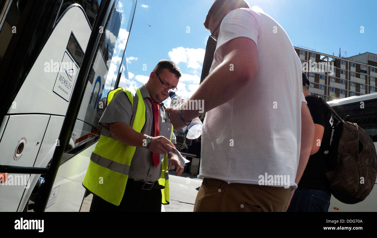 Bus driver checking tickets and passengers boarding a bus in summer at ...
