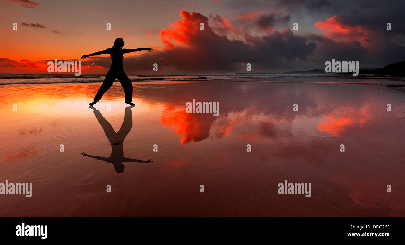 Silhouette of fitness person on a beach at sunset Stock Photo - Alamy