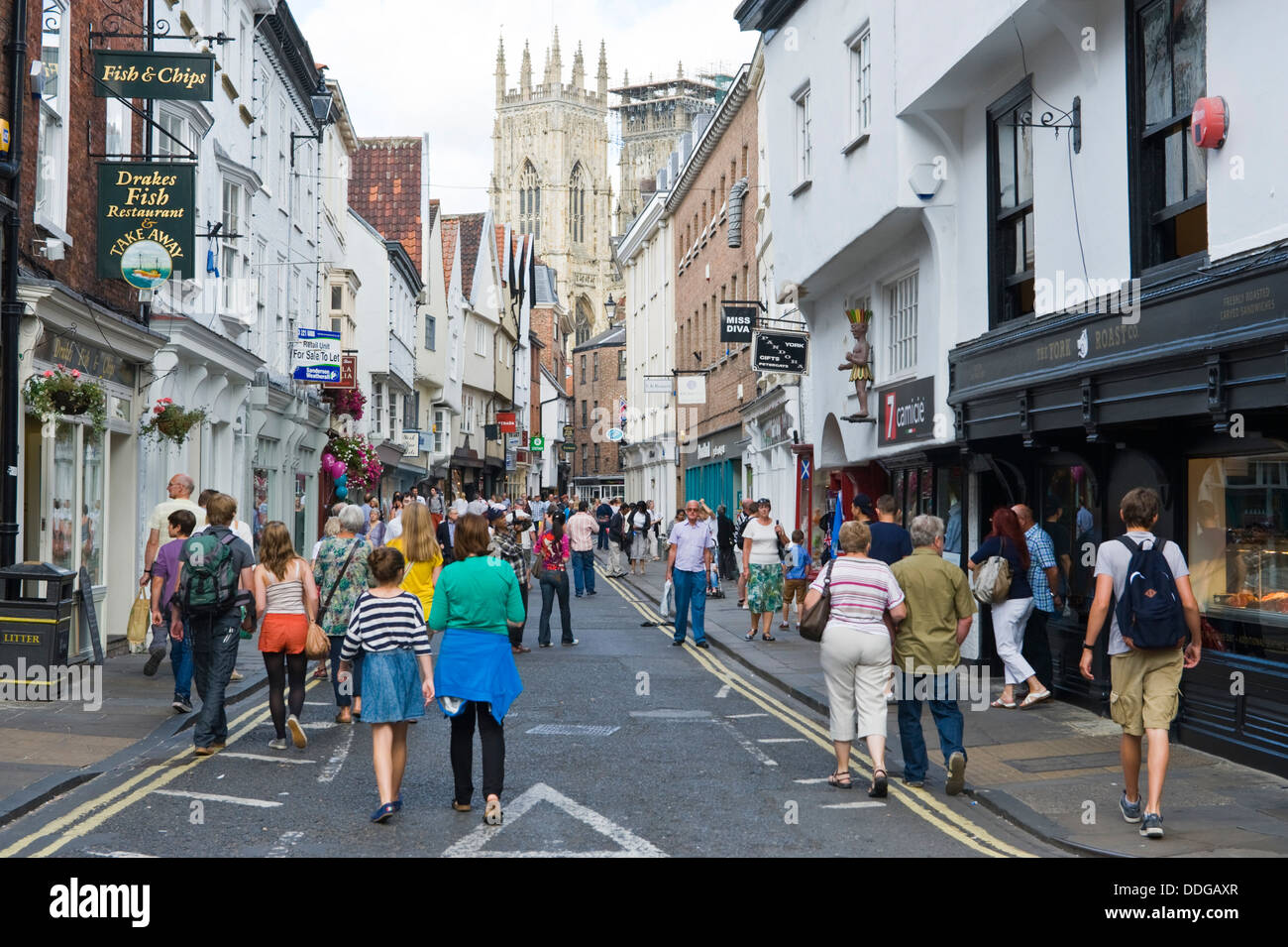 Shoppers and tourists on high street in the city centre of York North ...
