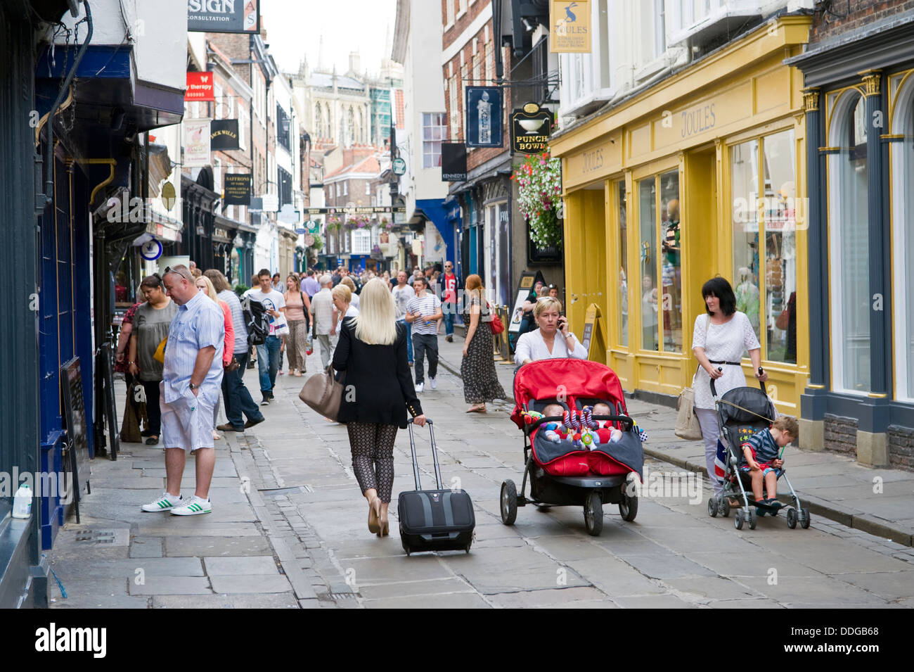 Shoppers and tourists on high street in the city centre of York North ...