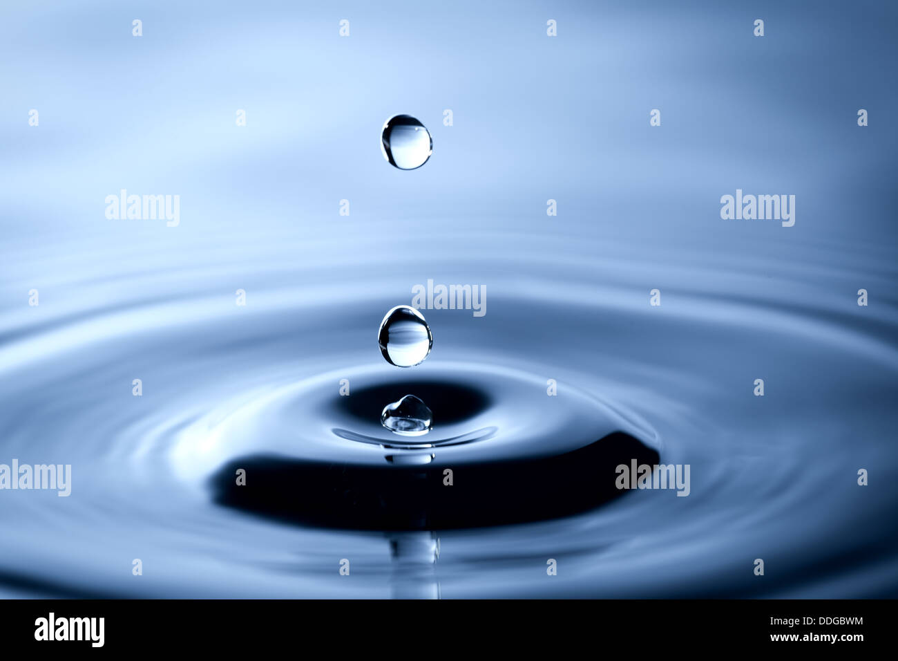 Water drop falling to a liquid surface Stock Photo - Alamy