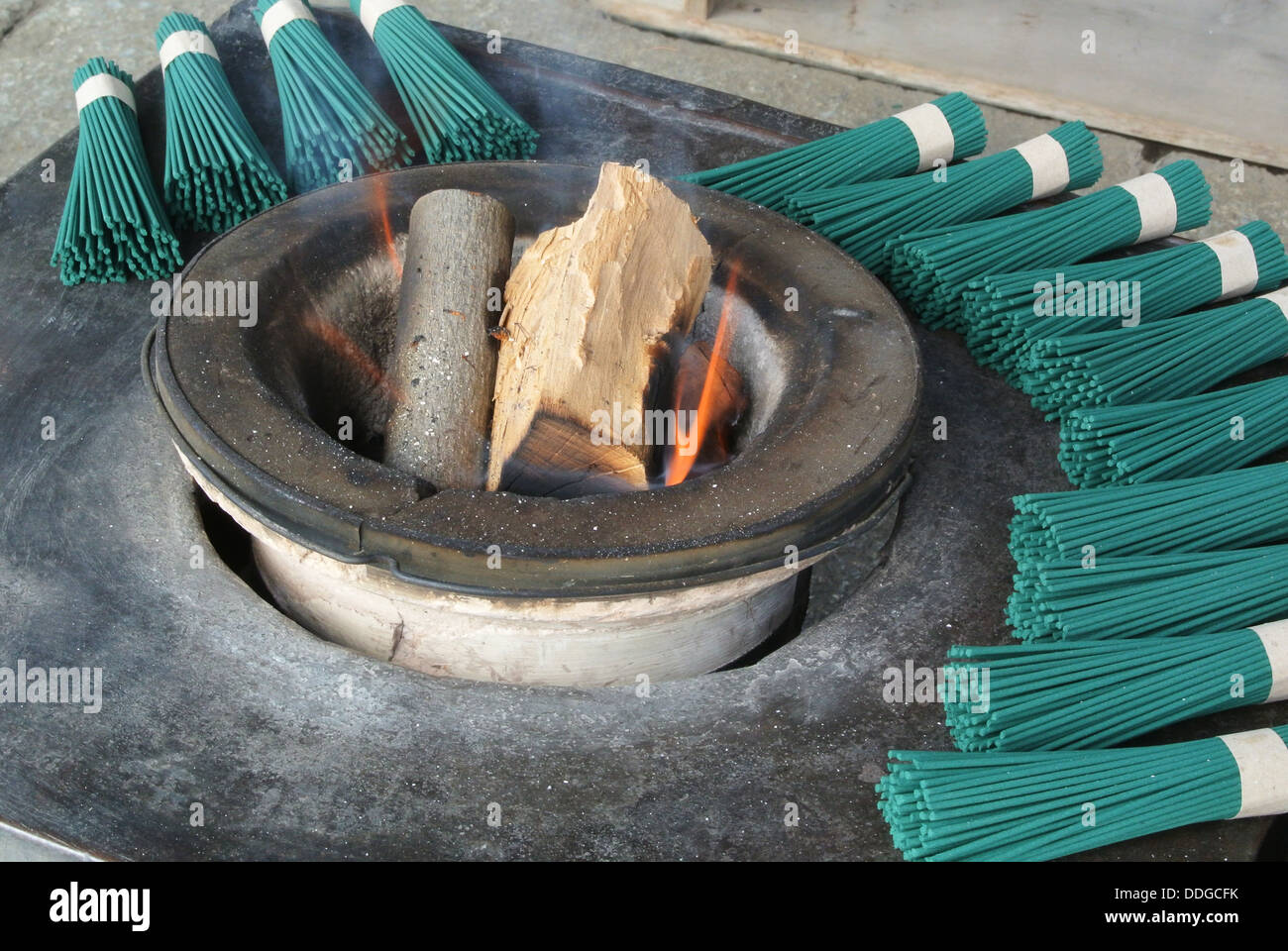 Green incense sticks surrounding a fire on a table at the Sengkuji ...