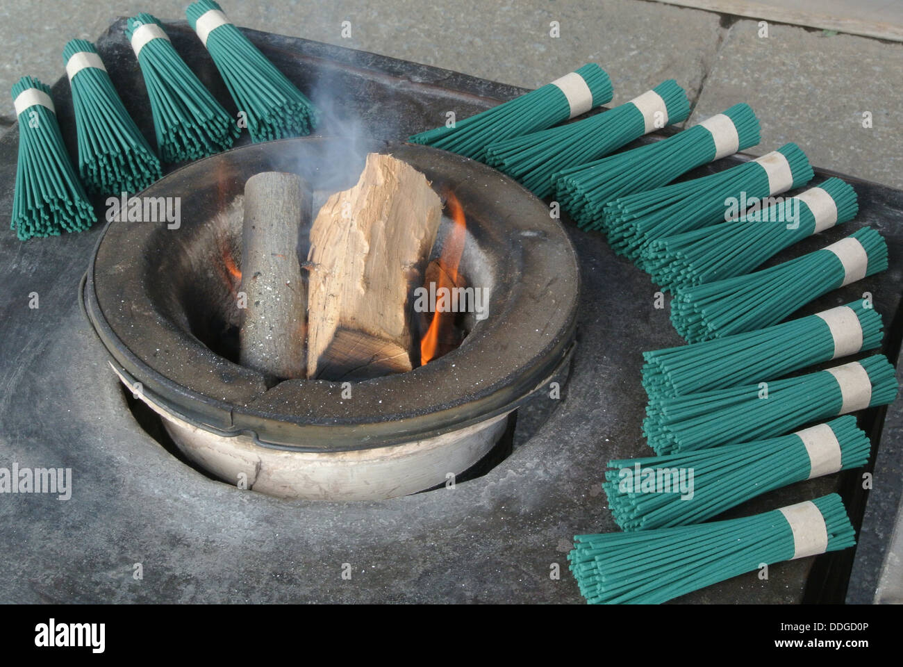 Green incense sticks surrounding a fire on a table at the Sengkuji ...