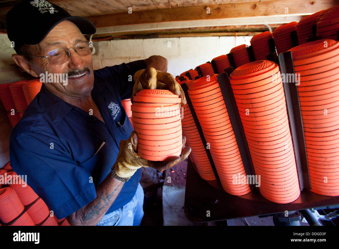 A range master loads clay targets, or clay pigeons, into a launcher at ...
