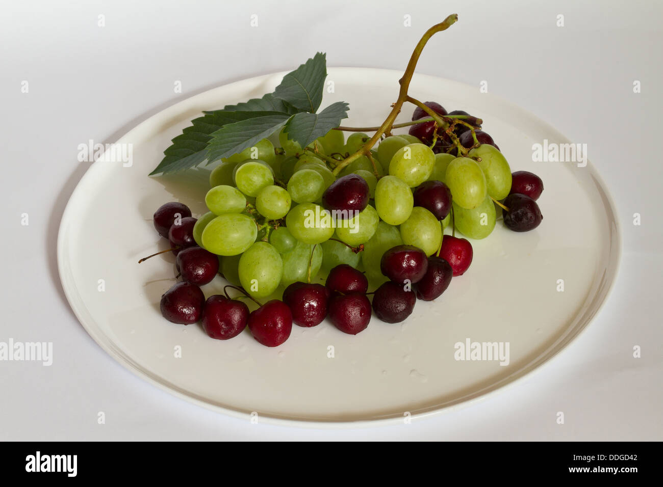 Simple still life with grape and cherry Stock Photo - Alamy