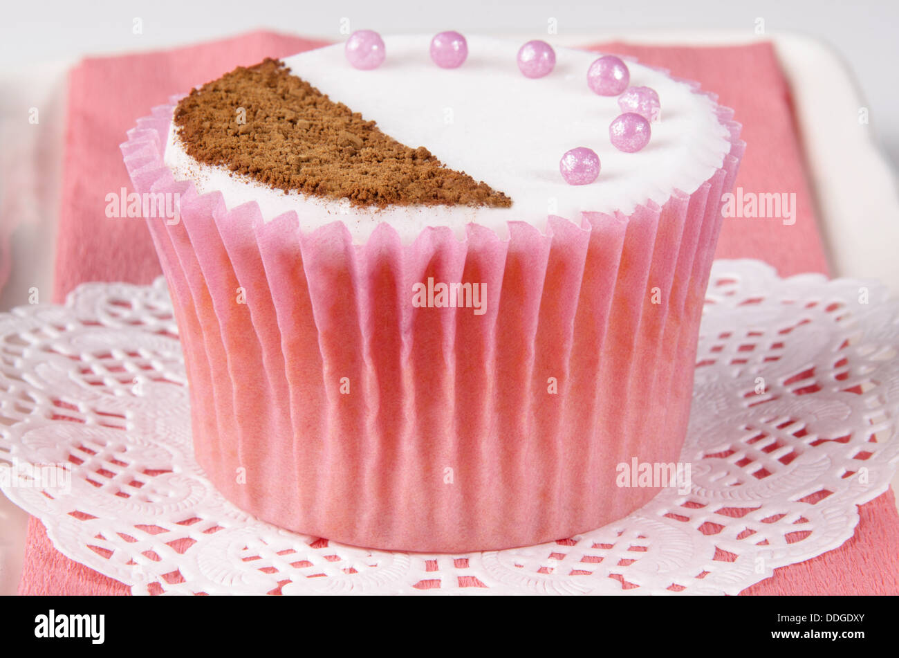 cupcake with cocoa powder and pink pearls Stock Photo - Alamy