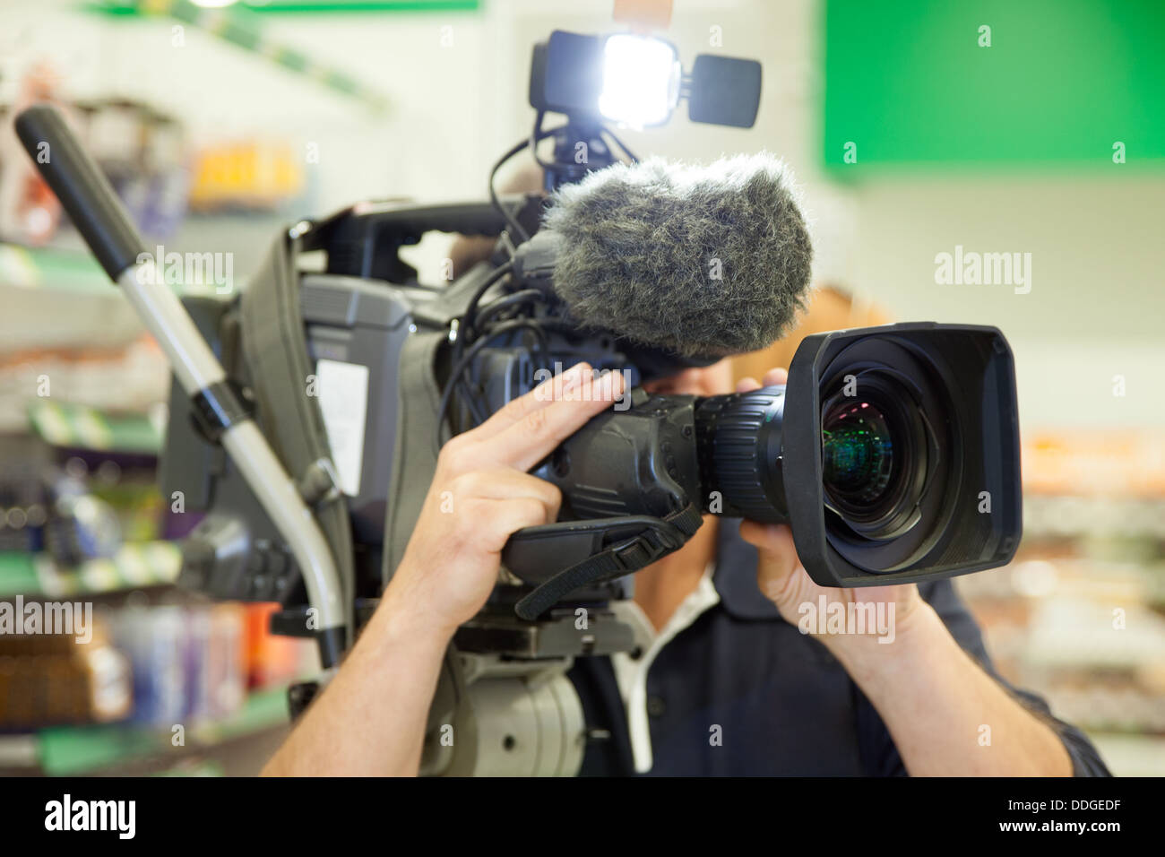 Movie operator taking footage with high end camera with LED lights on ...