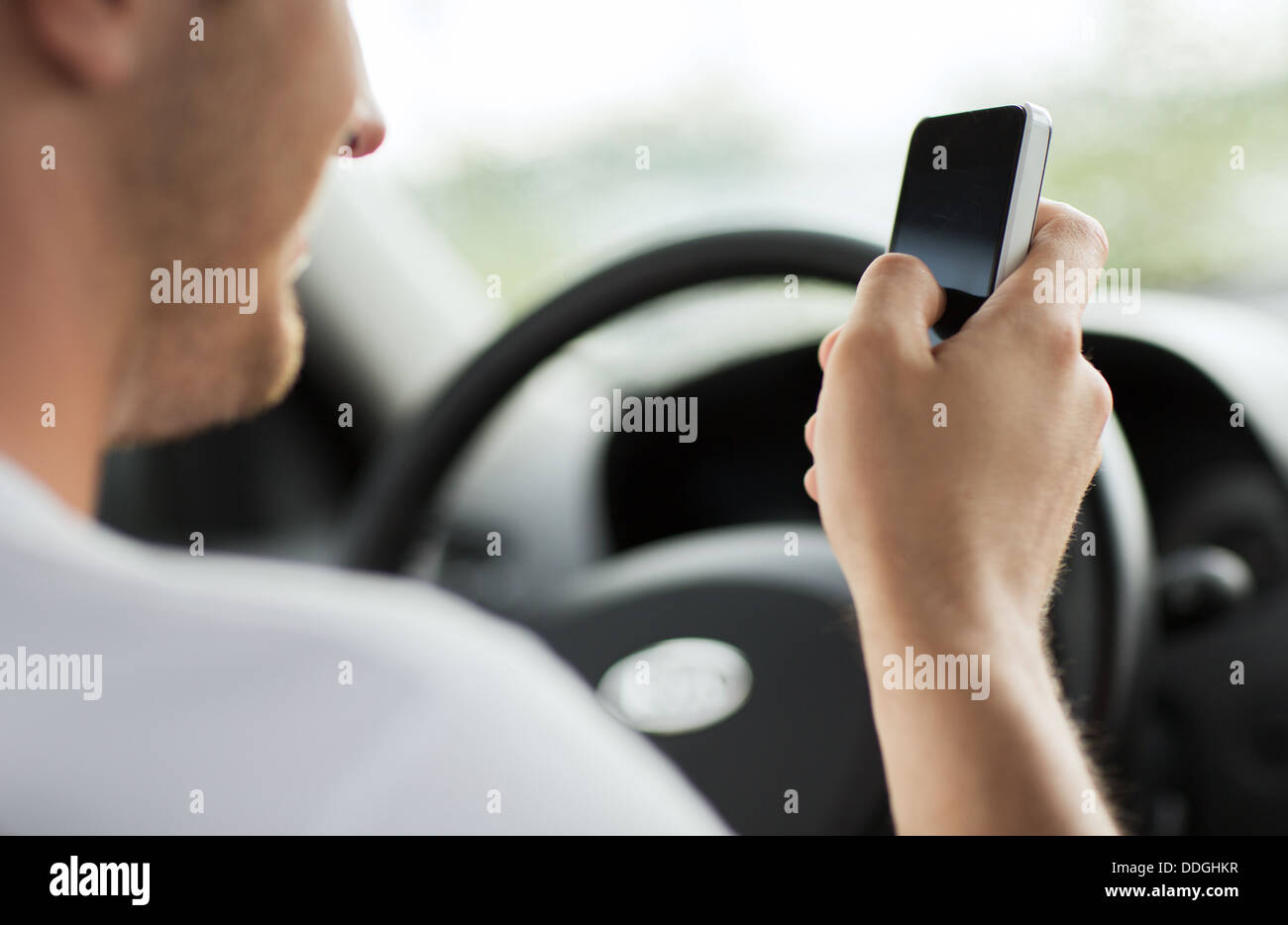 man using phone while driving the car Stock Photo - Alamy