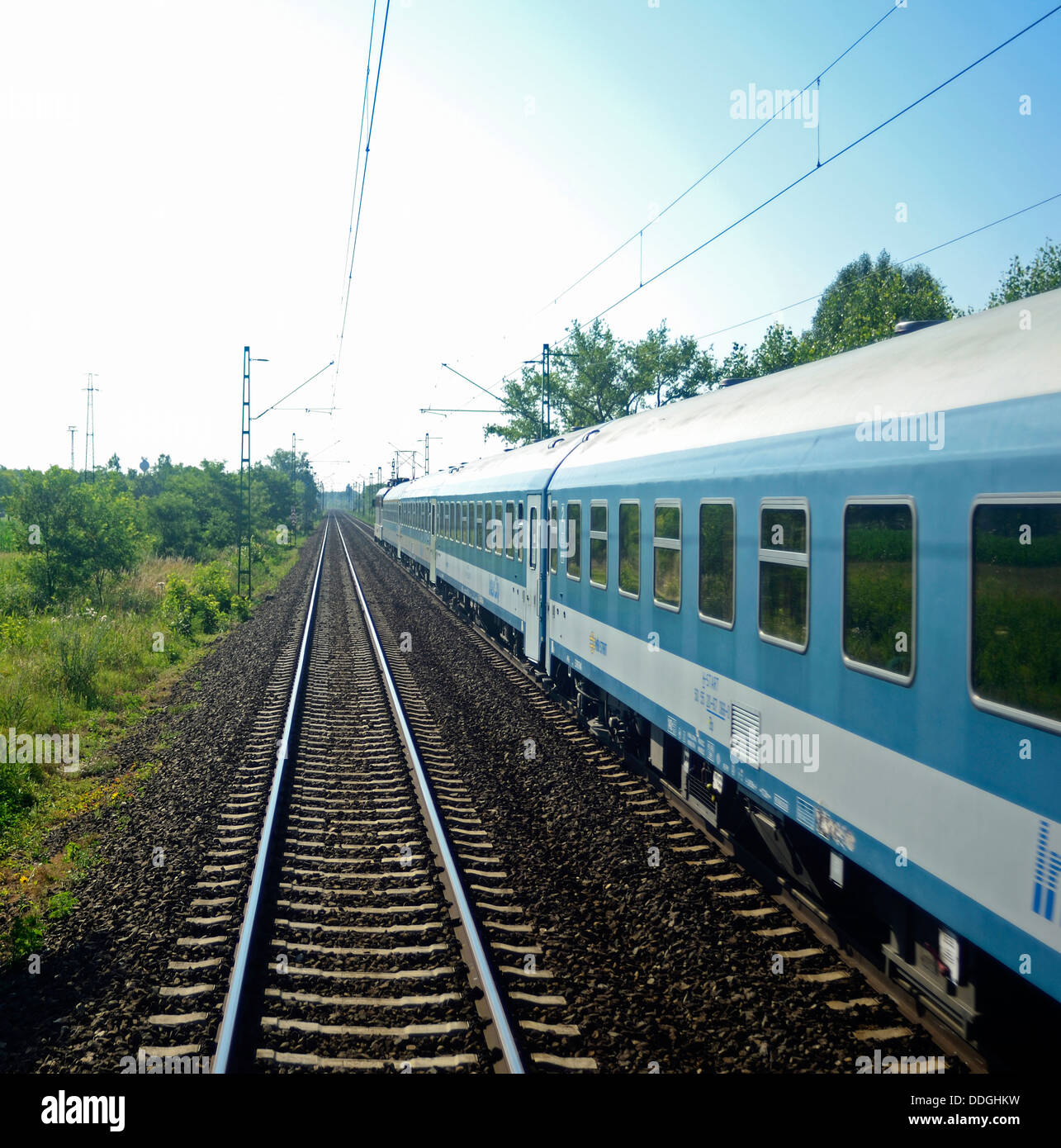 Train on open field taken from another train Stock Photo - Alamy
