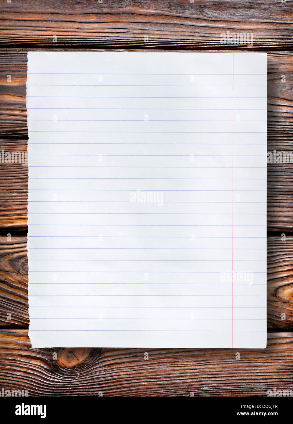 Lined paper on dark table Stock Photo - Alamy