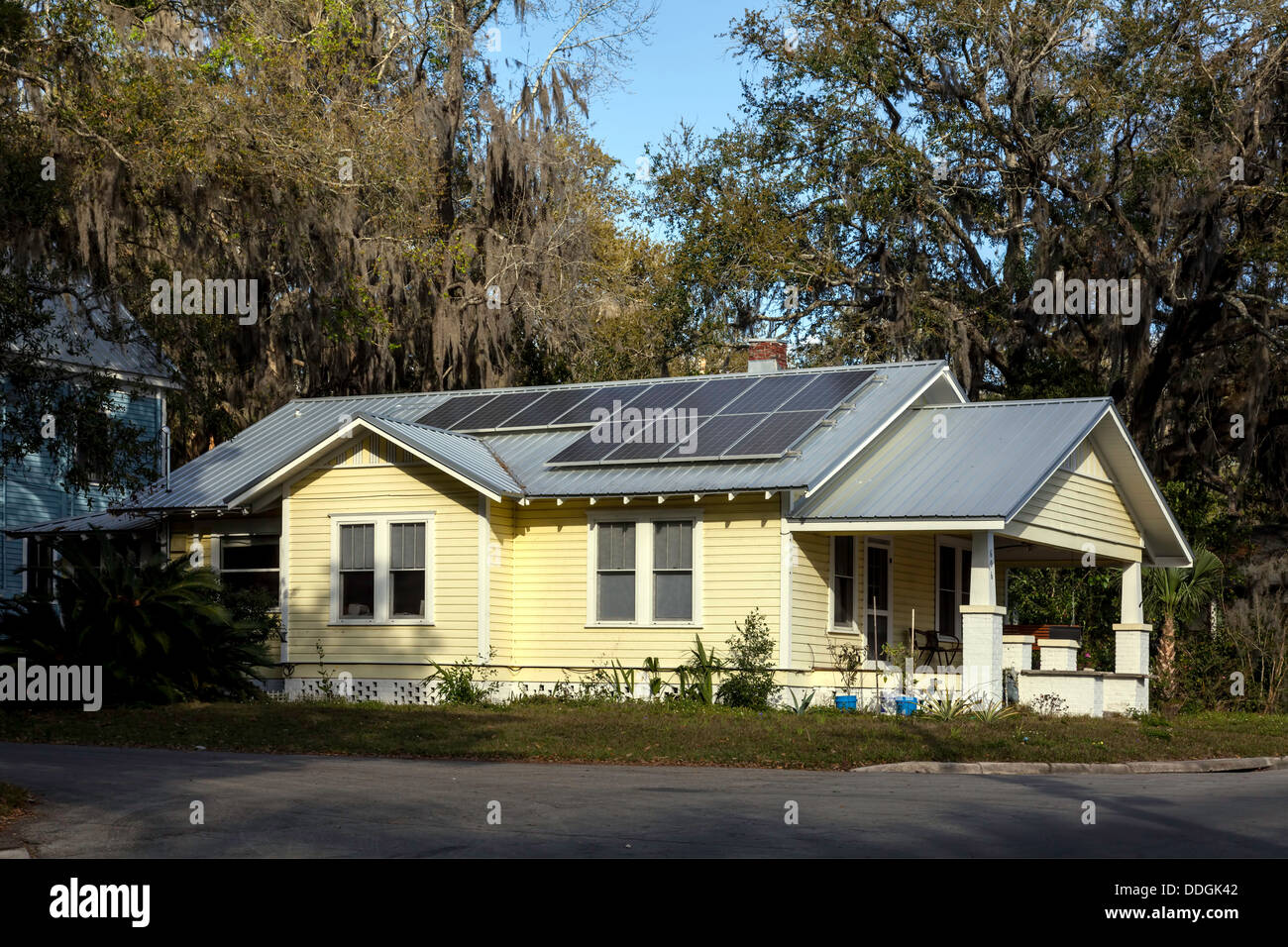 Cute yellow bungalow house with sustainable renovations including solar ...