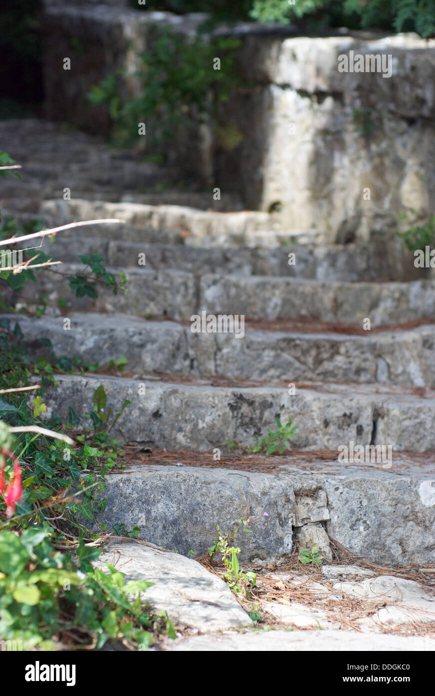 stone path leading up a hill with a wall on one side Stock Photo - Alamy