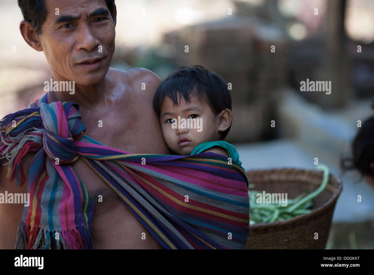 A Bom male carries his child in a traditional sling close to Bandarban ...