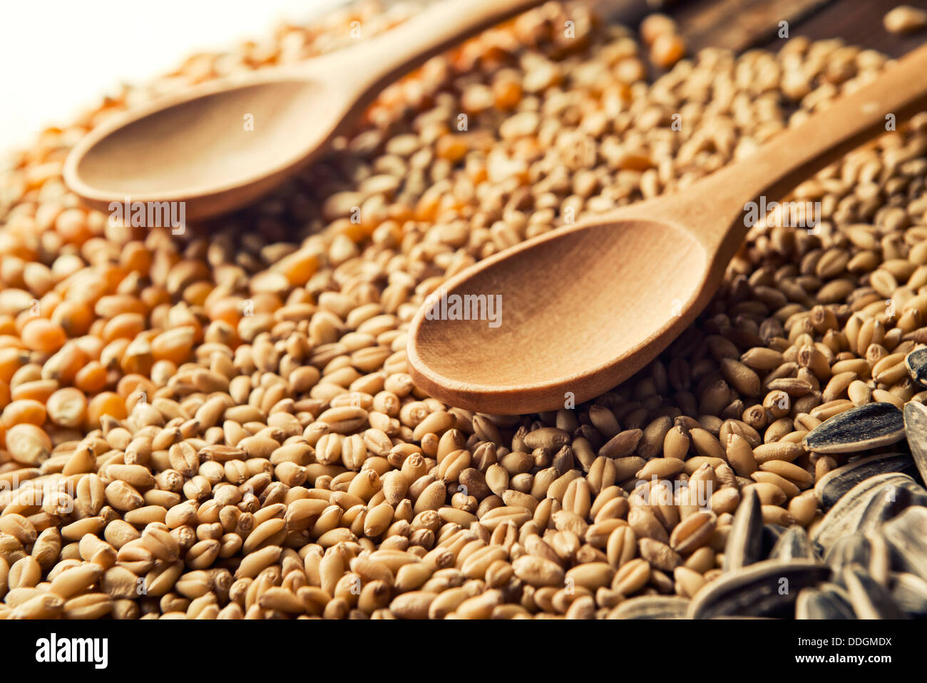 Wood spoons and cereal grains on wooden table Stock Photo - Alamy