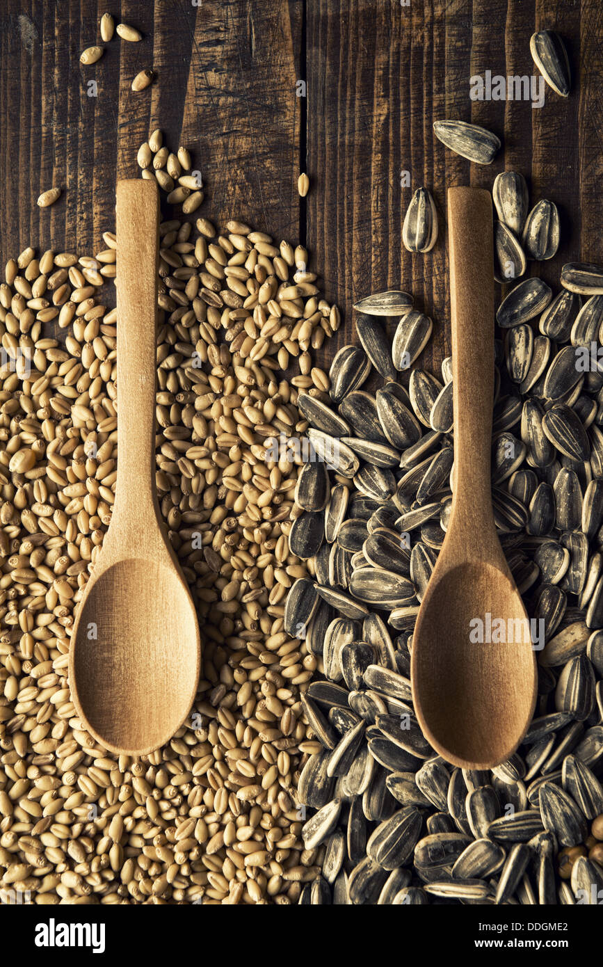 Wood spoons and cereal grains on wooden table Stock Photo - Alamy