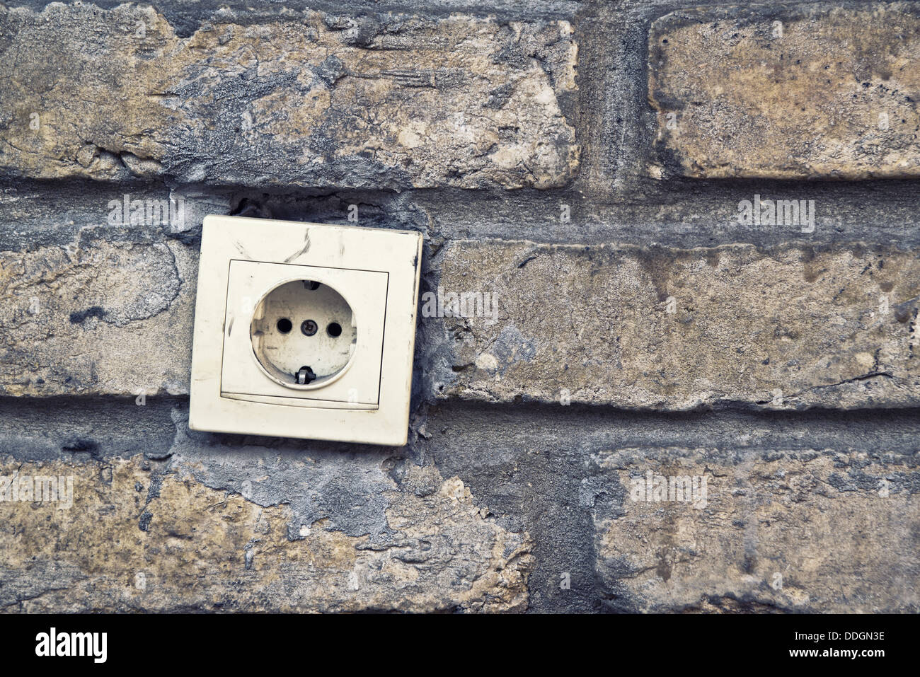 Old plastic electric plug connector, ac outlet, on brick wall Stock ...