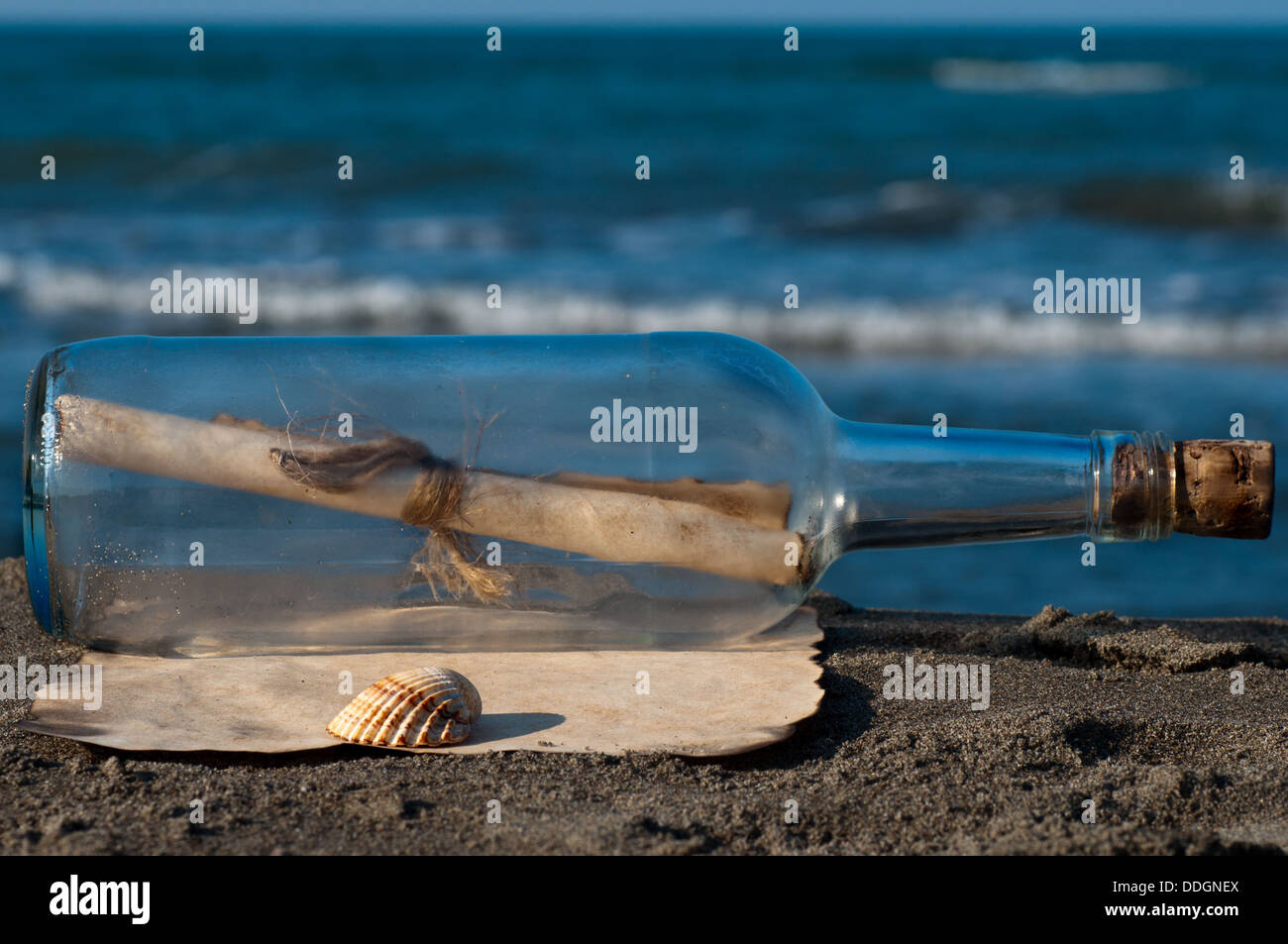 Message in a bottle stranded on the beach Stock Photo - Alamy