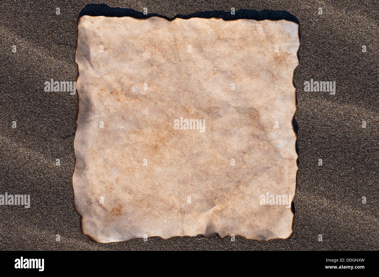 Old vintage paper on the sand Stock Photo - Alamy