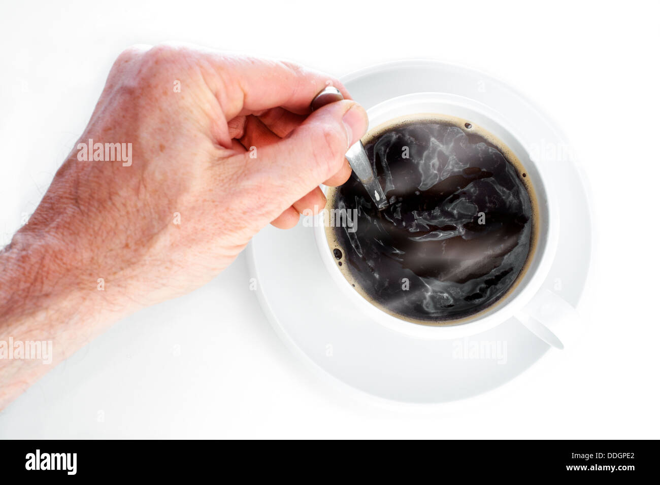 Hand stirring a white cup of Coffee on a white isolated background ...