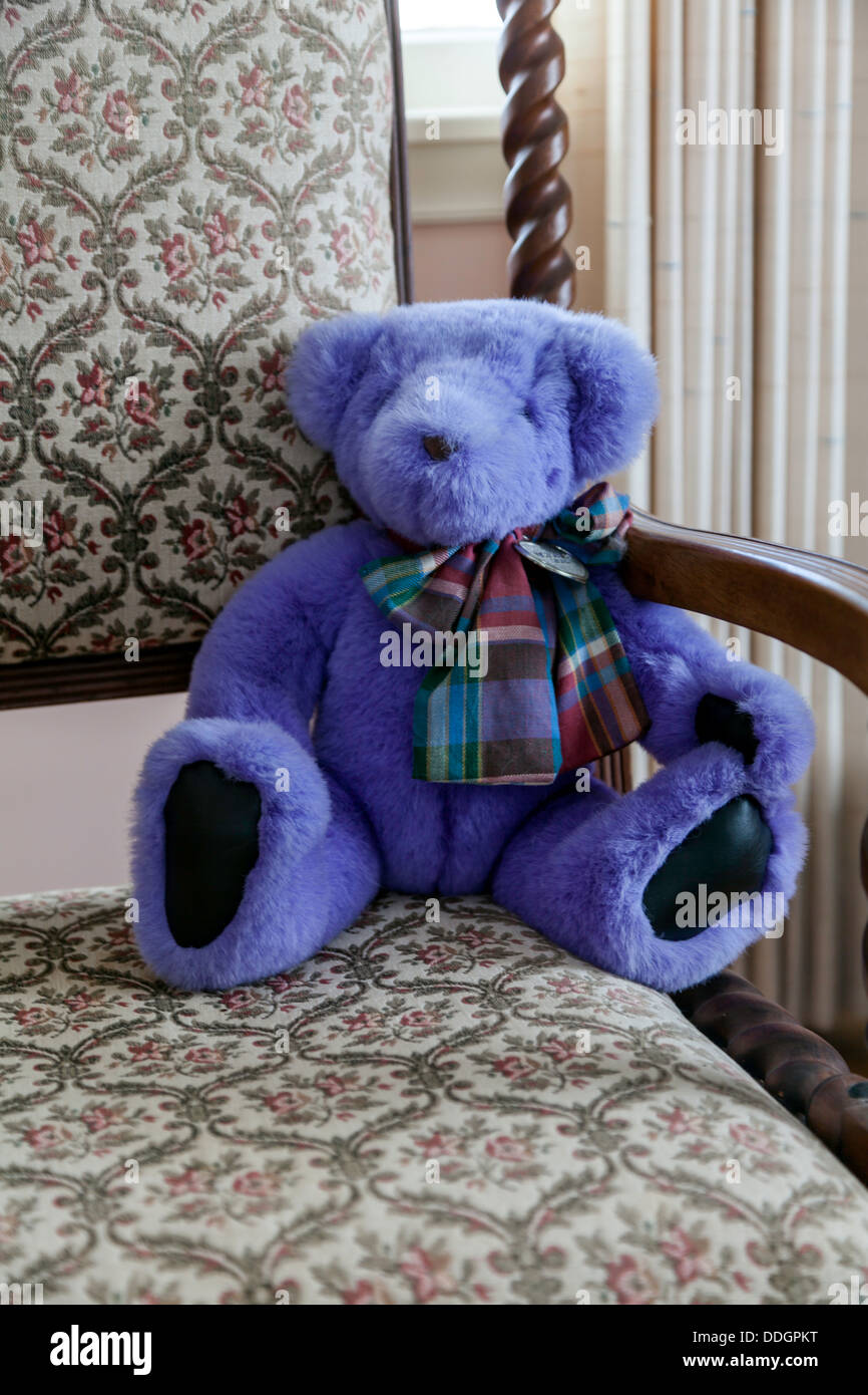 Stuffed purple lavender teddy bear with a colorful plaid bow sitting on ...