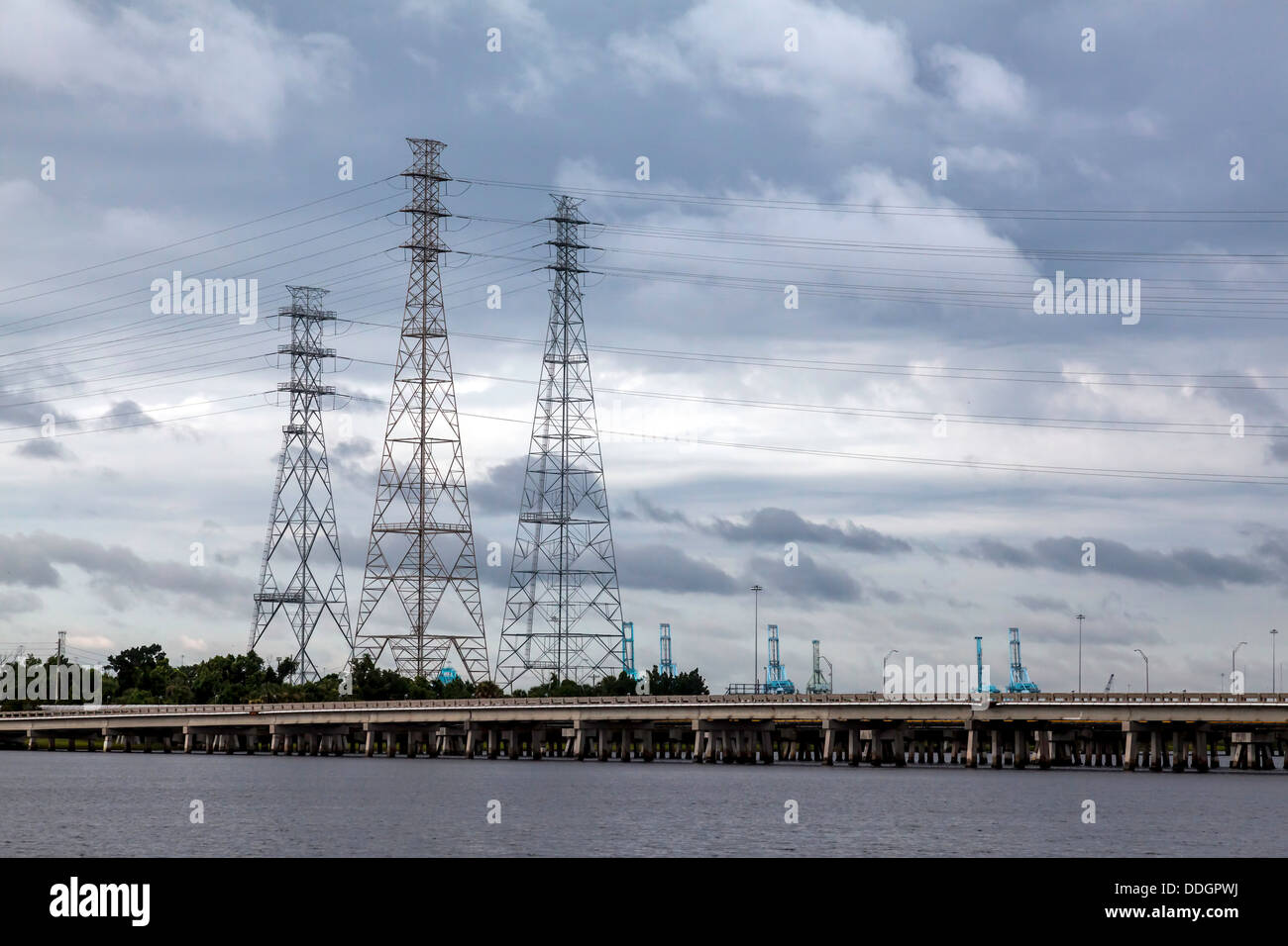 High voltage power transmission lines and towers with concrete highway ...