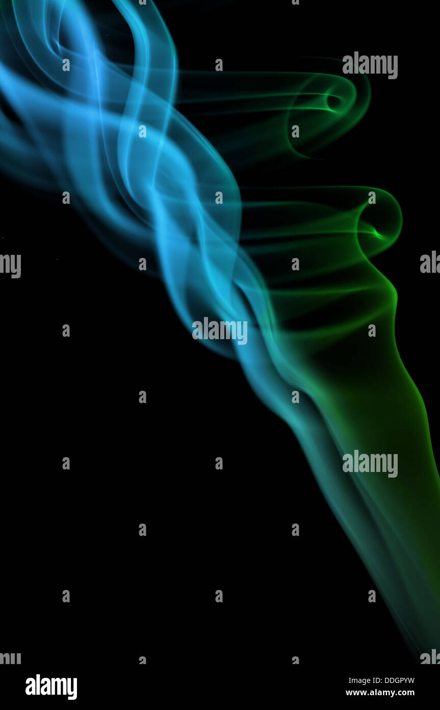 Blue and green smoke on black background Stock Photo - Alamy