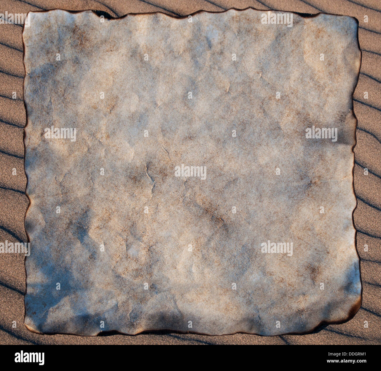 Old vintage paper on the sand Stock Photo - Alamy