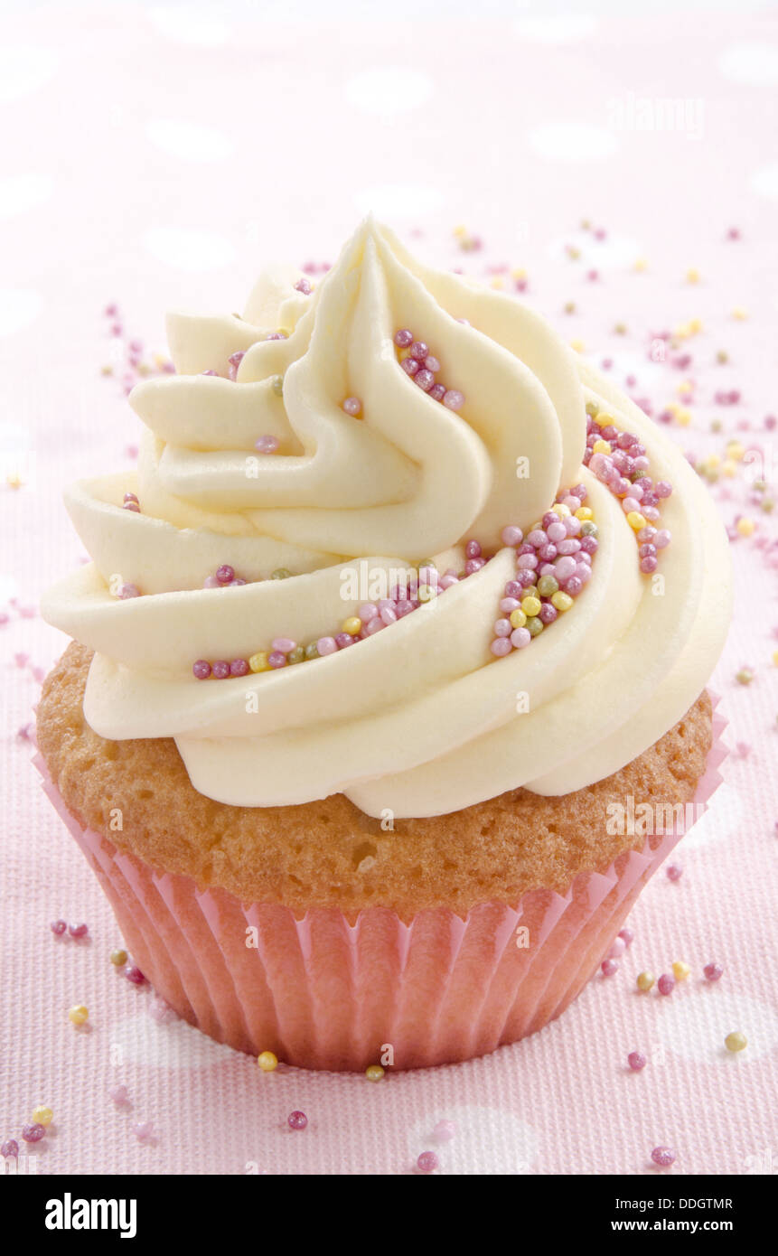 vanilla cupcake with colorful sprinkles Stock Photo - Alamy