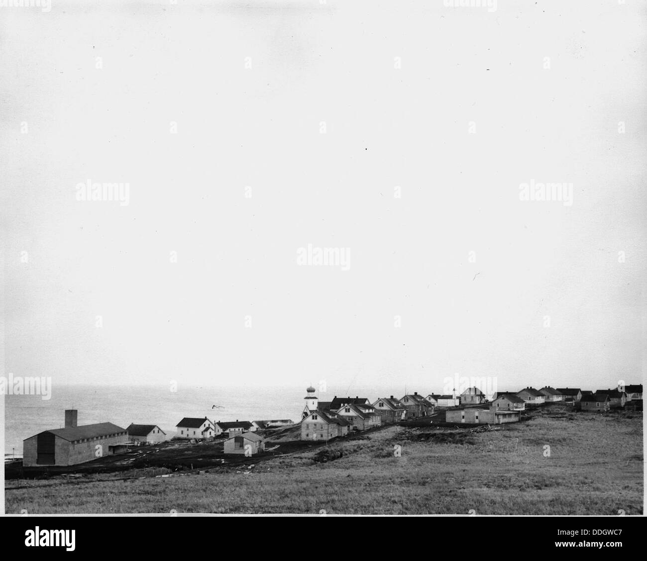 A photograph titled 'Village', showing a rural community or small ...