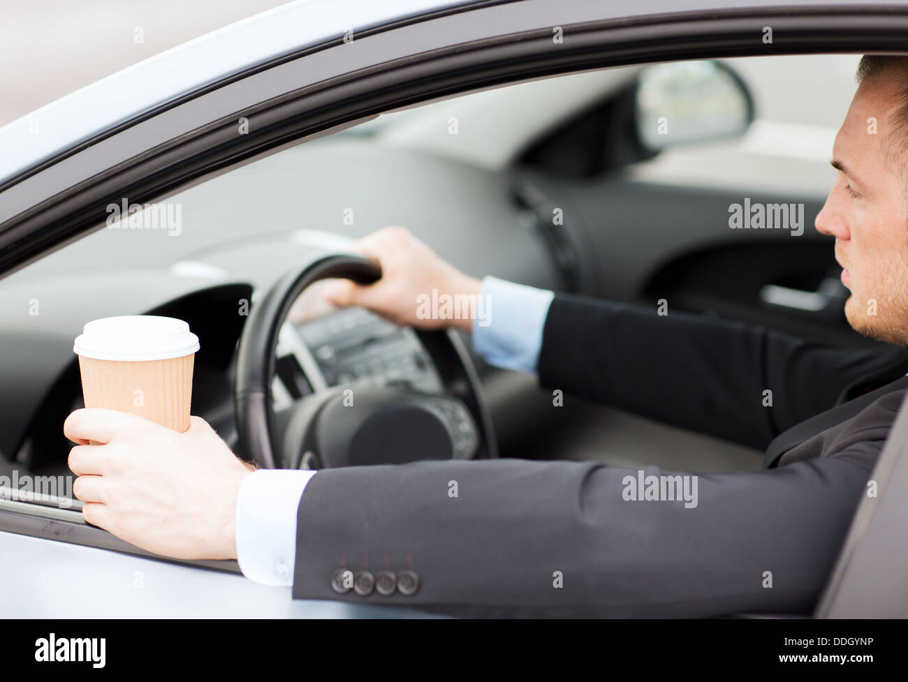 man drinking coffee while driving the car Stock Photo - Alamy