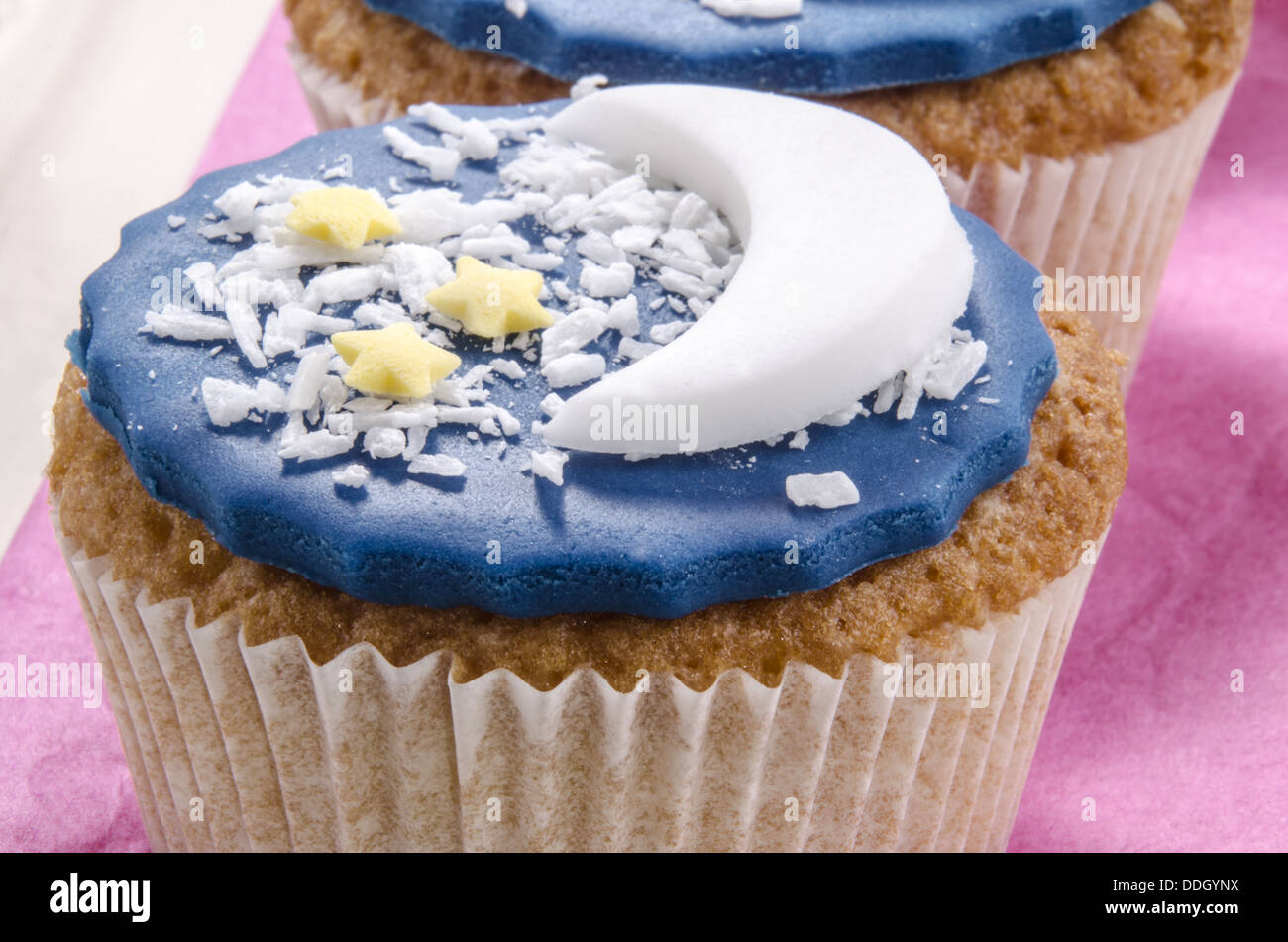 cupcake with blue icing and half moon Stock Photo - Alamy