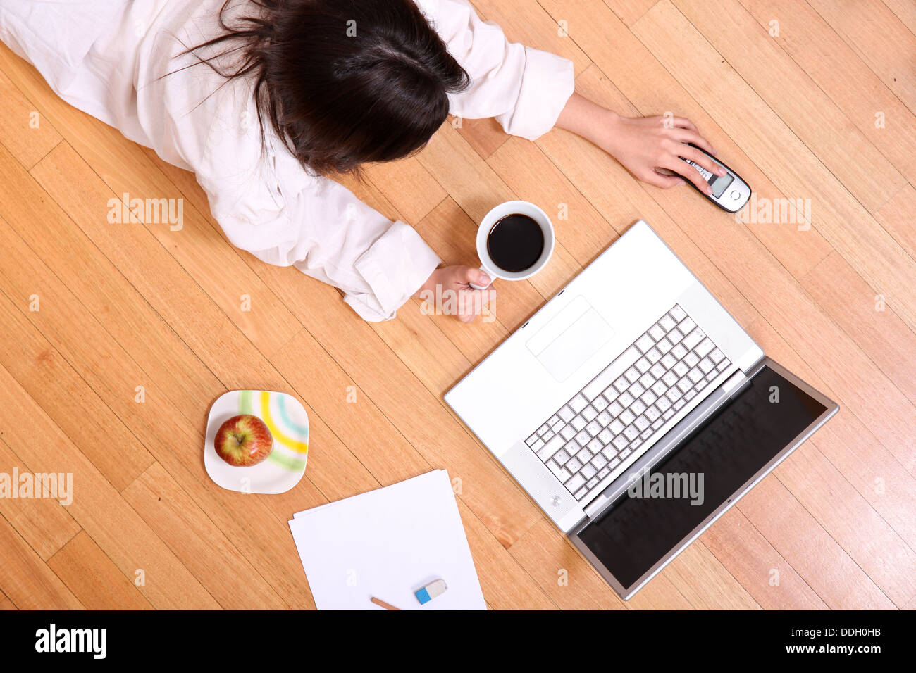 A young adult woman studying on the floor Stock Photo - Alamy