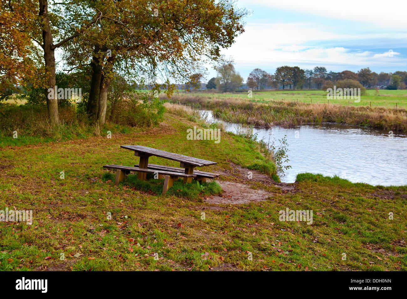wooden table and benches by river Stock Photo - Alamy