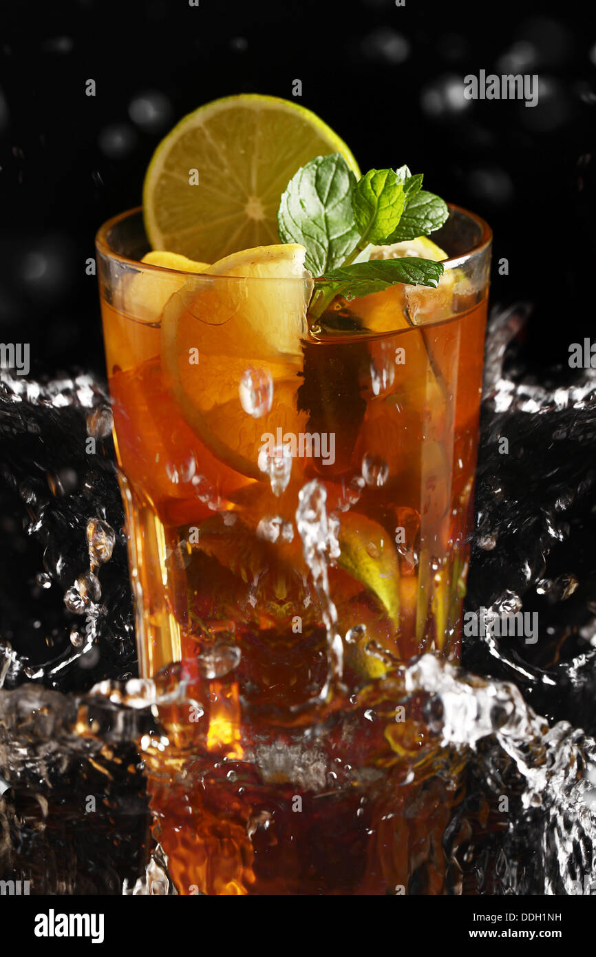 Cold tea with lemon and mint in water splashing Stock Photo - Alamy